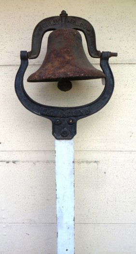 Old cast iron school bell on wooden post signed : Lot 471